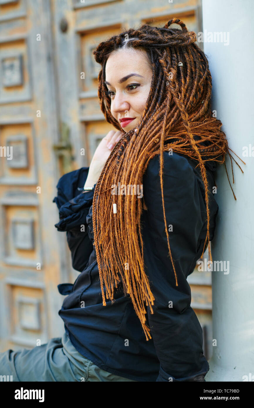 dreadlocks fashionable girl posing at old wooden door background Stock ...