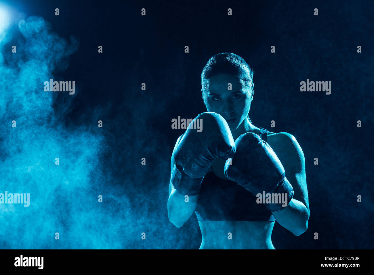 Front view of serious boxer in boxing gloves looking at camera Stock ...