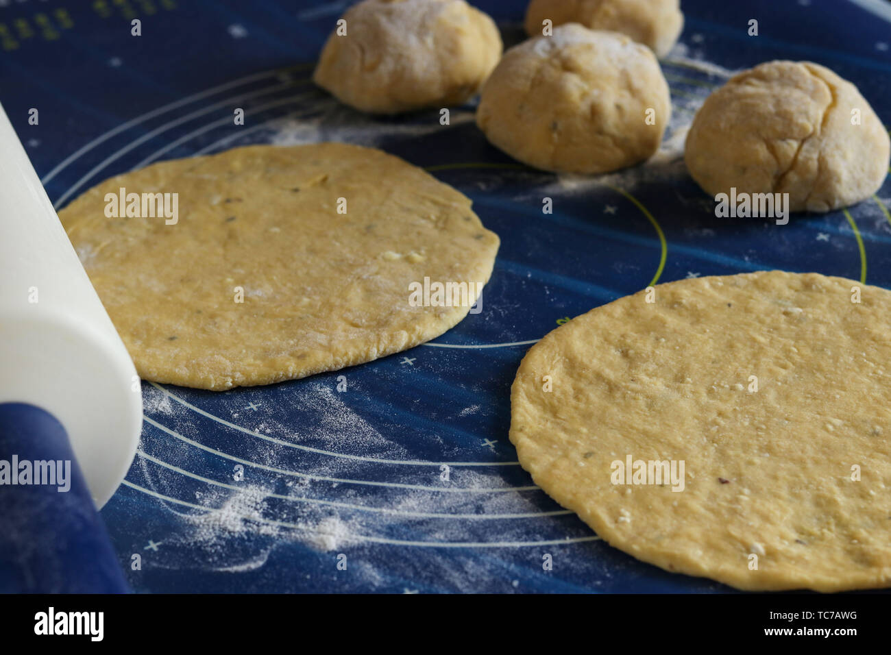 Process of making bread: the dough is rolled out on the working surface ...