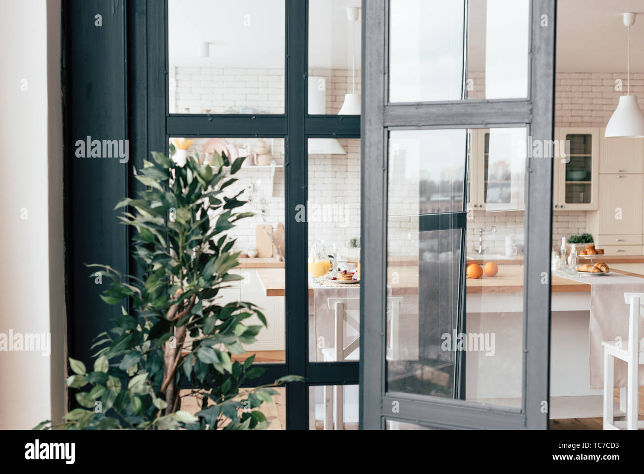 open kitchen windows, served table with food and green plant Stock ...