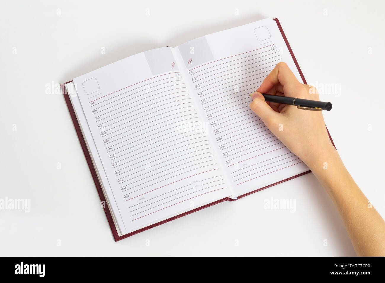 Hand with pen is ready to write in an open notebook. Opened notebook ...