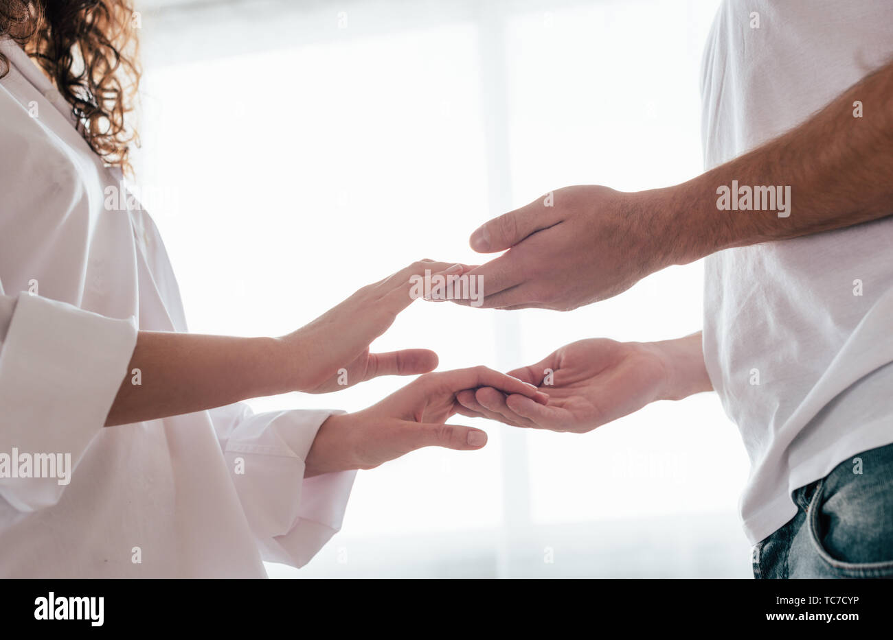 partial view of loving couple holding hands at home Stock Photo - Alamy