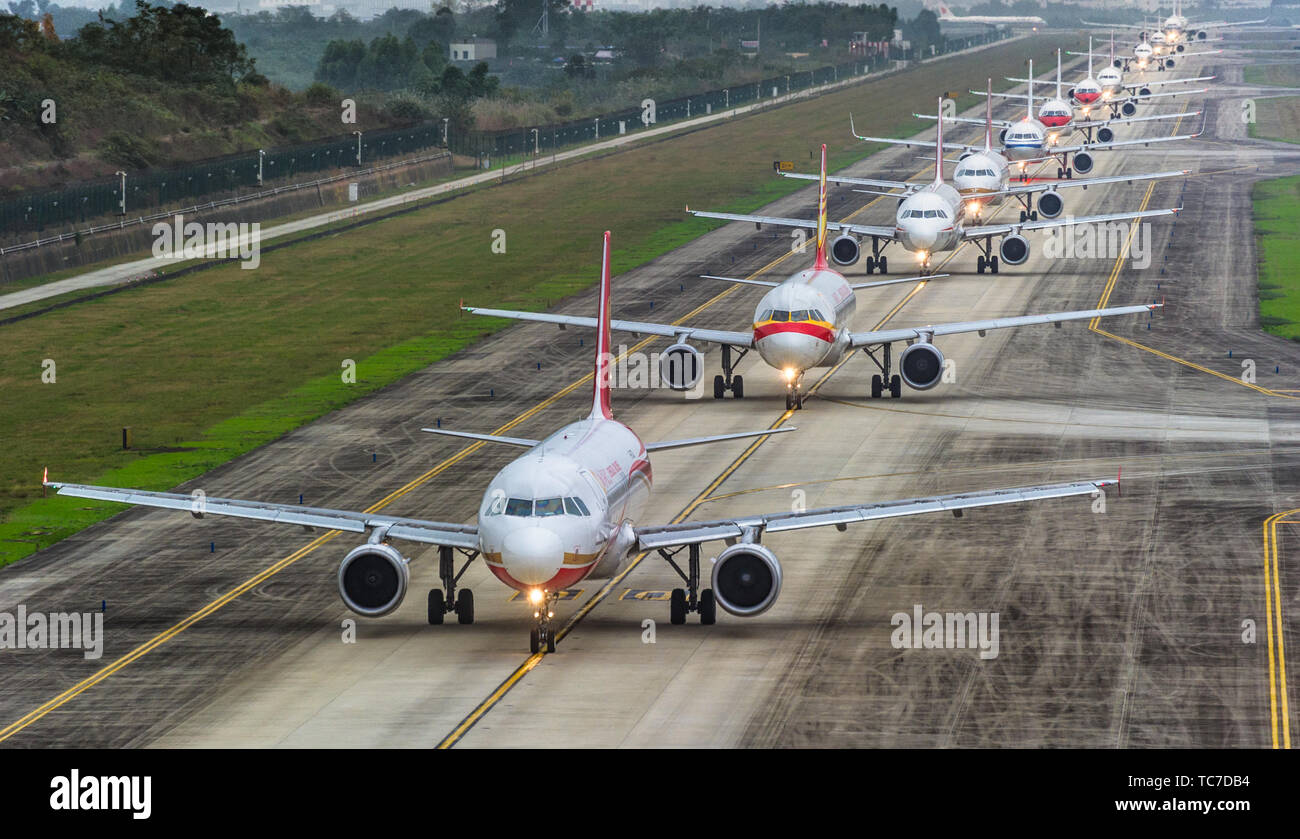 Civil aircraft waiting in line to take off Stock Photo - Alamy