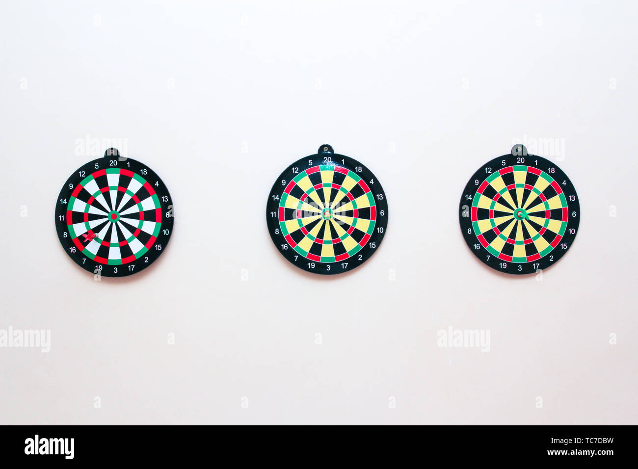 Dartboard with a dart on a gray wall close up. Darts game Stock Photo ...