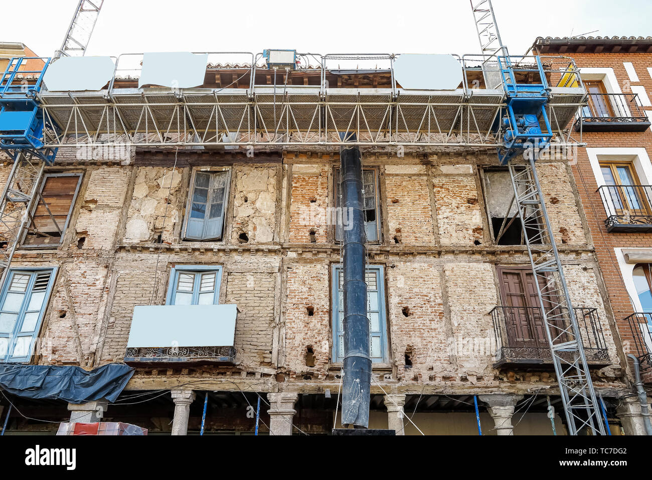 front view of ruined facade of a building in restoration Stock Photo ...