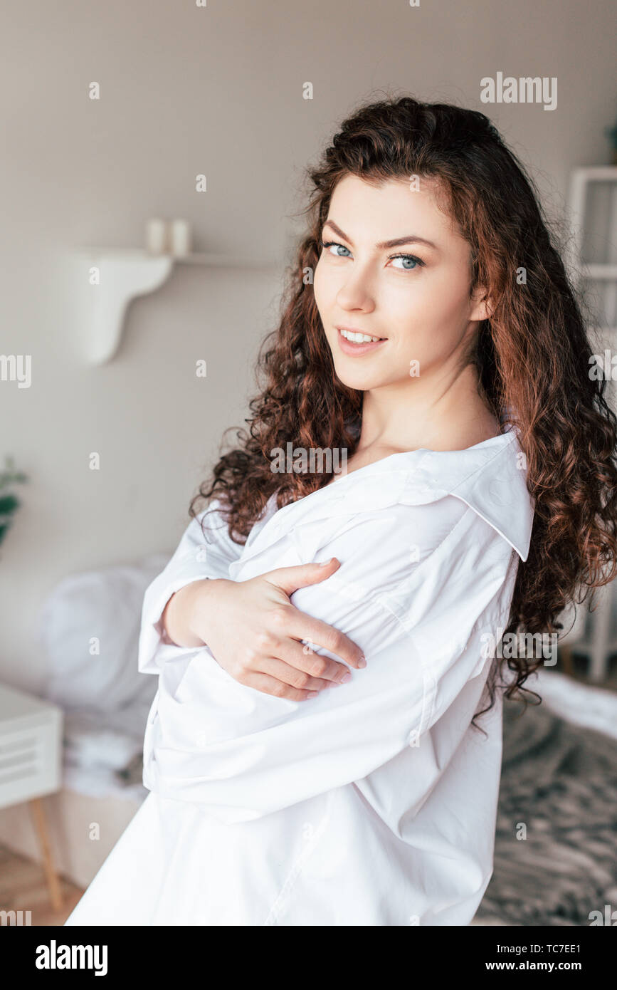 beautiful curious girl in white shirt looking at camera Stock Photo - Alamy