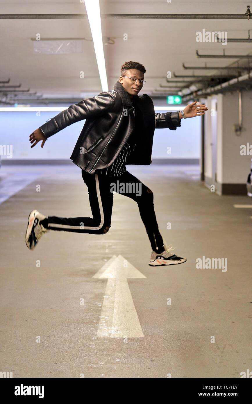 young man jumping in parking garage Stock Photo - Alamy