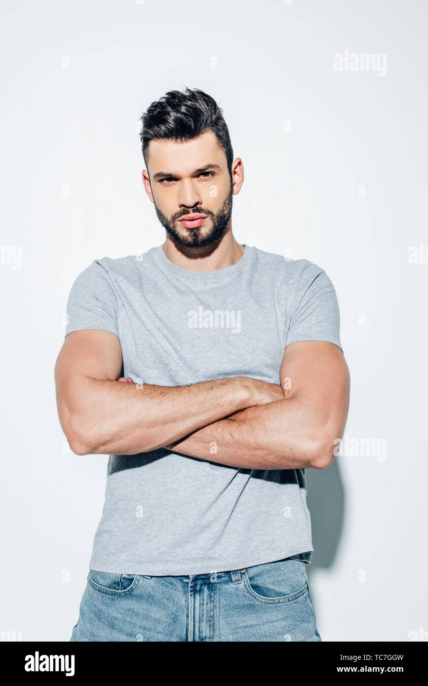 handsome bearded man standing with crossed arms on white Stock Photo ...