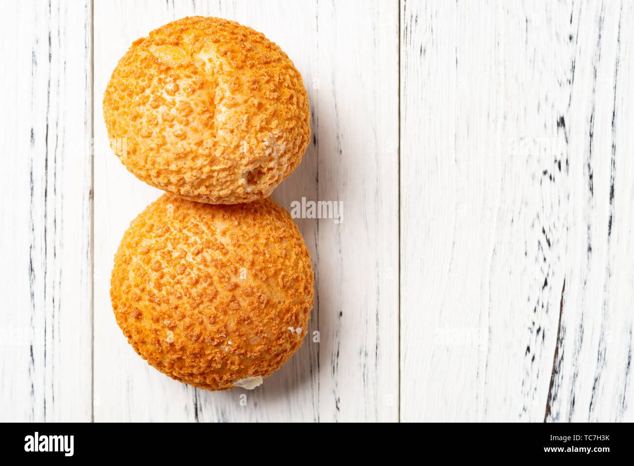 top view two pieces sweet puffs on a white wood table with copy space ...