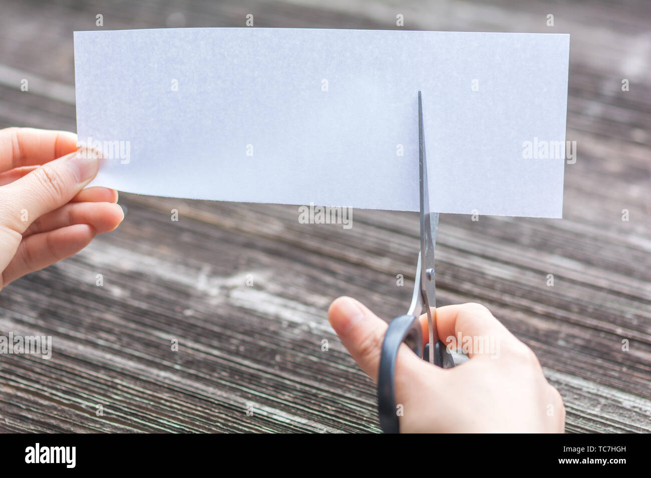 woman cutting paper by scissors Stock Photo - Alamy