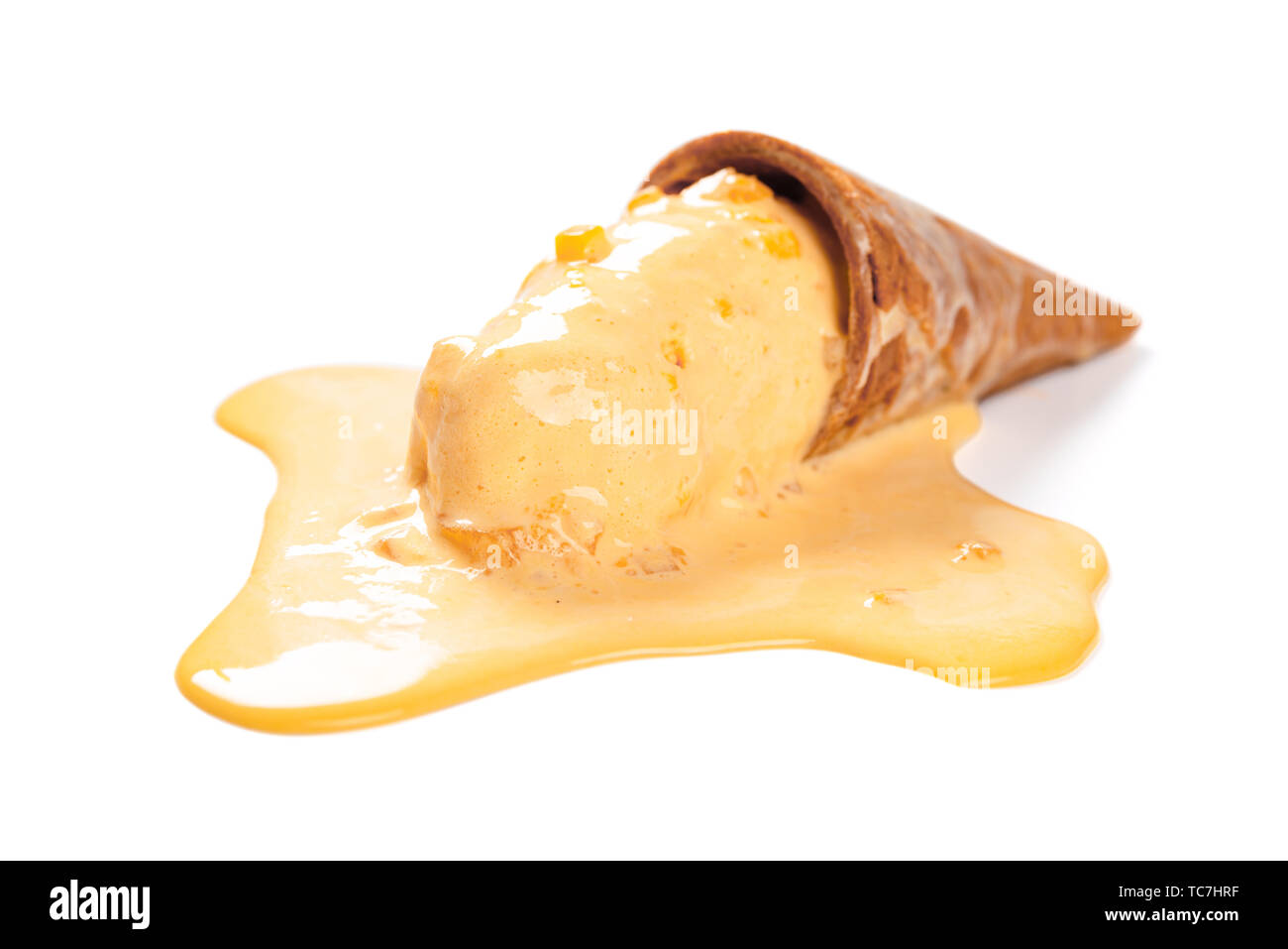 side view mango flavor ice cream cone in a melting process on white ...