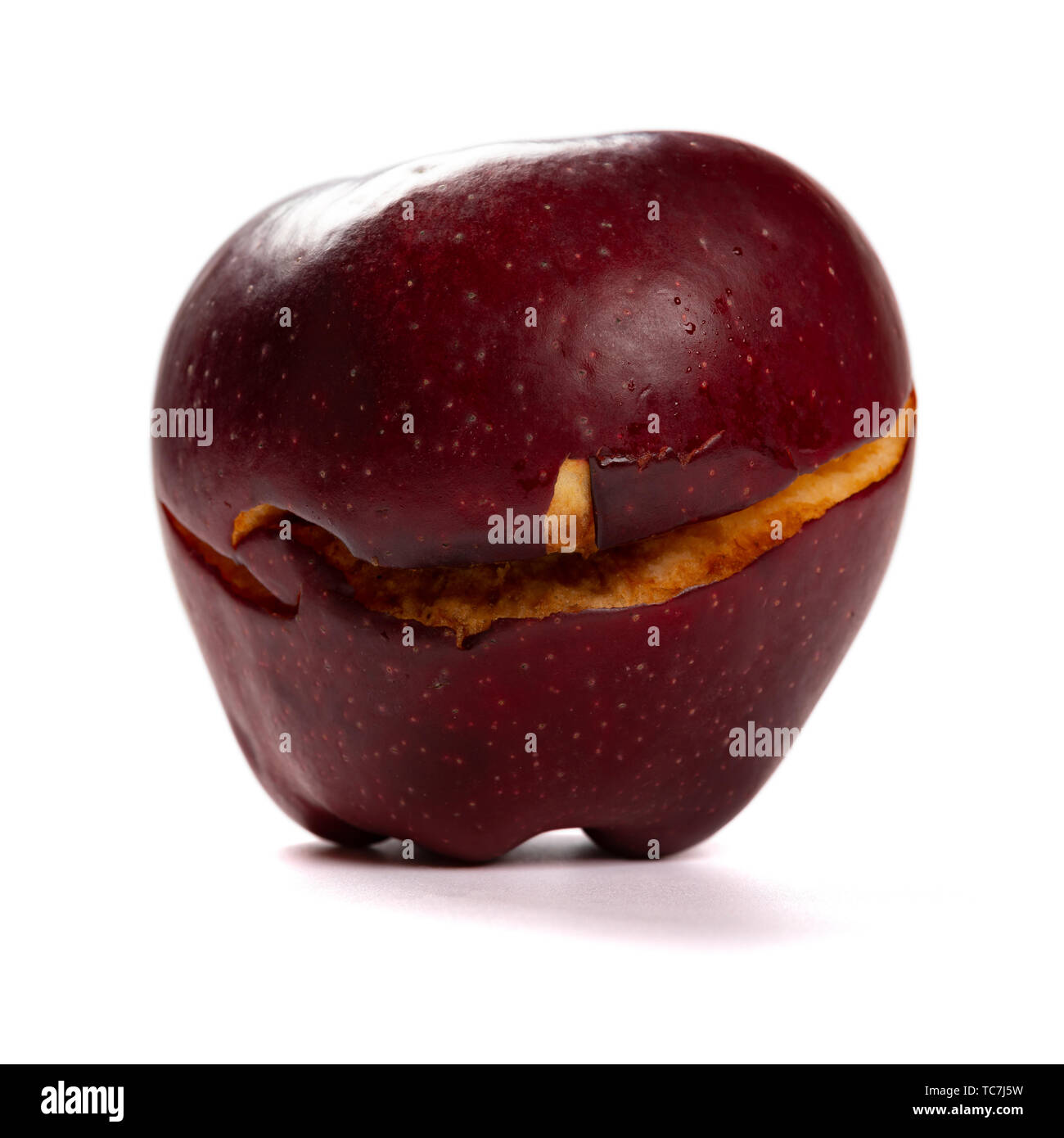 overripe apple with a crack on white background Stock Photo - Alamy