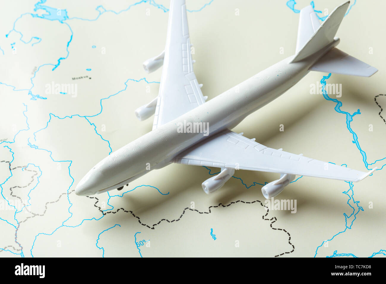 miniature of a passenger aircraft flying on a map Stock Photo - Alamy