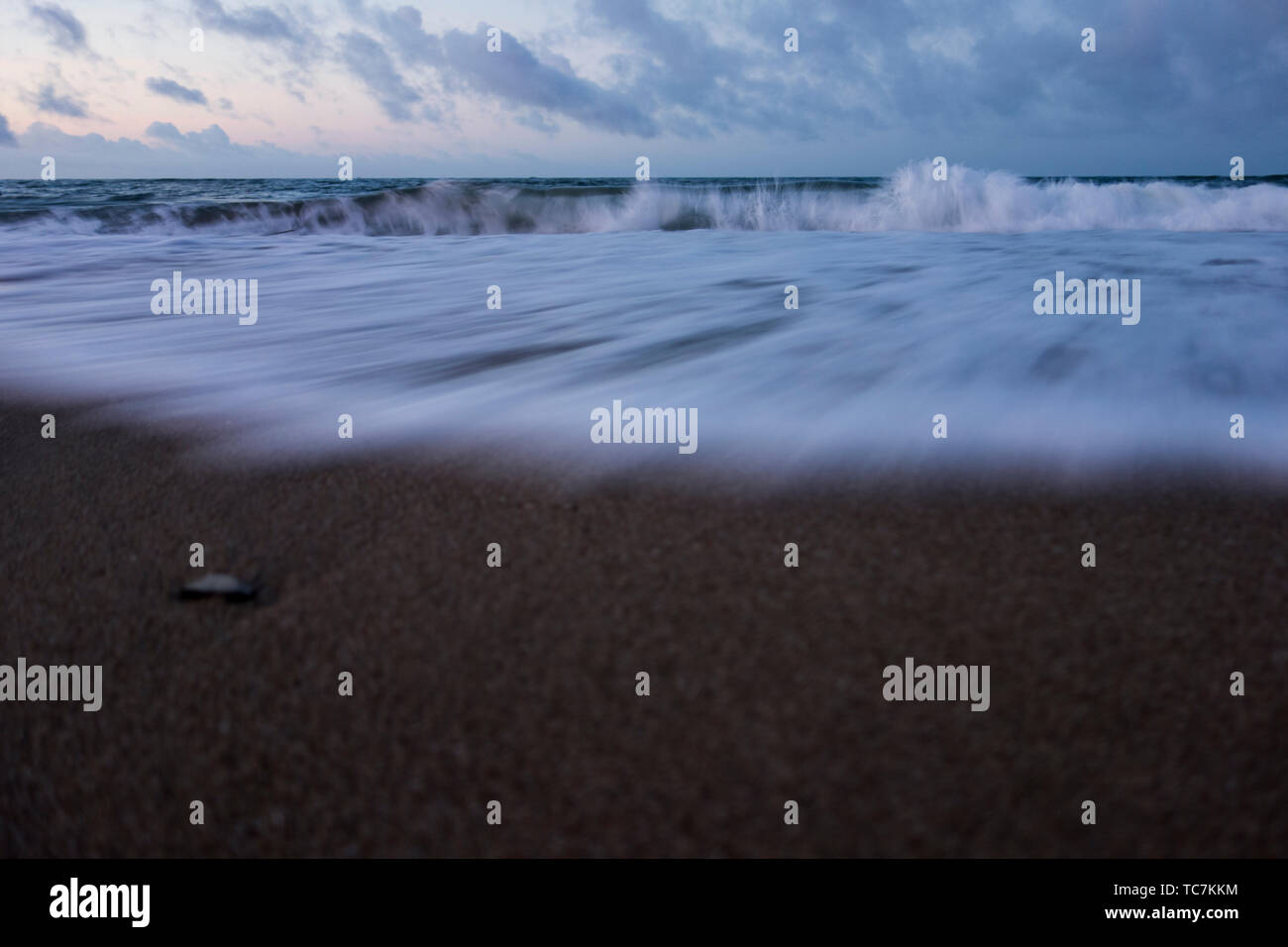 The waves hit the beach Stock Photo - Alamy
