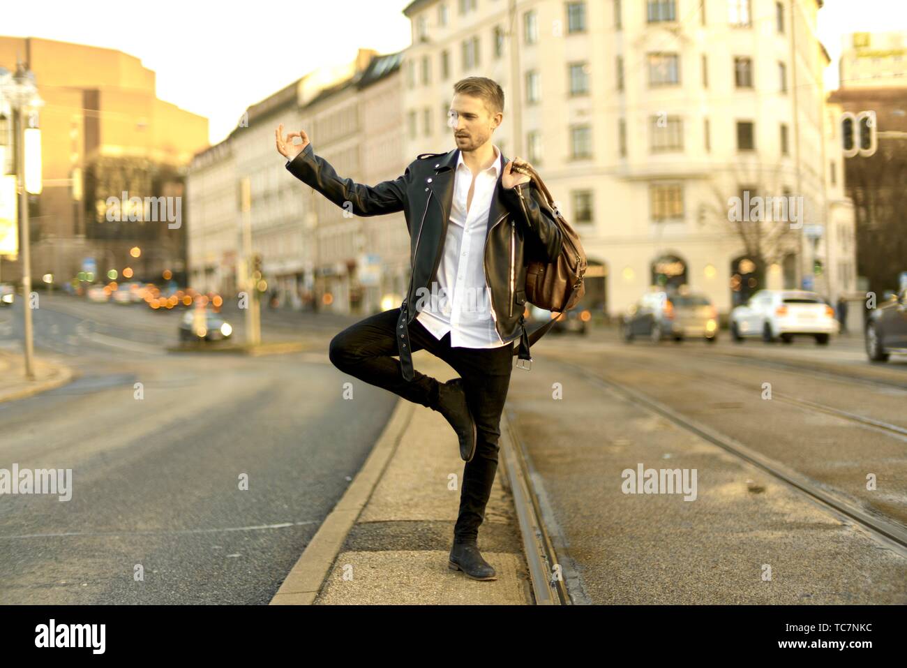 man balancing in middle of street, city, Munich, Germany Stock Photo ...