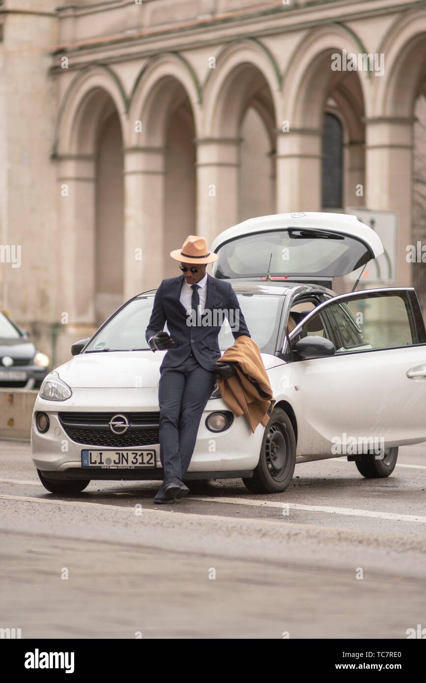 Man Leaning Against Car Stock Photos & Man Leaning Against Car Stock ...