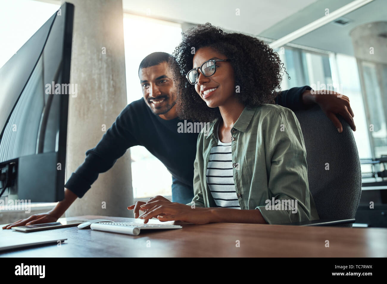 Two professional business people working together in office Stock Photo ...