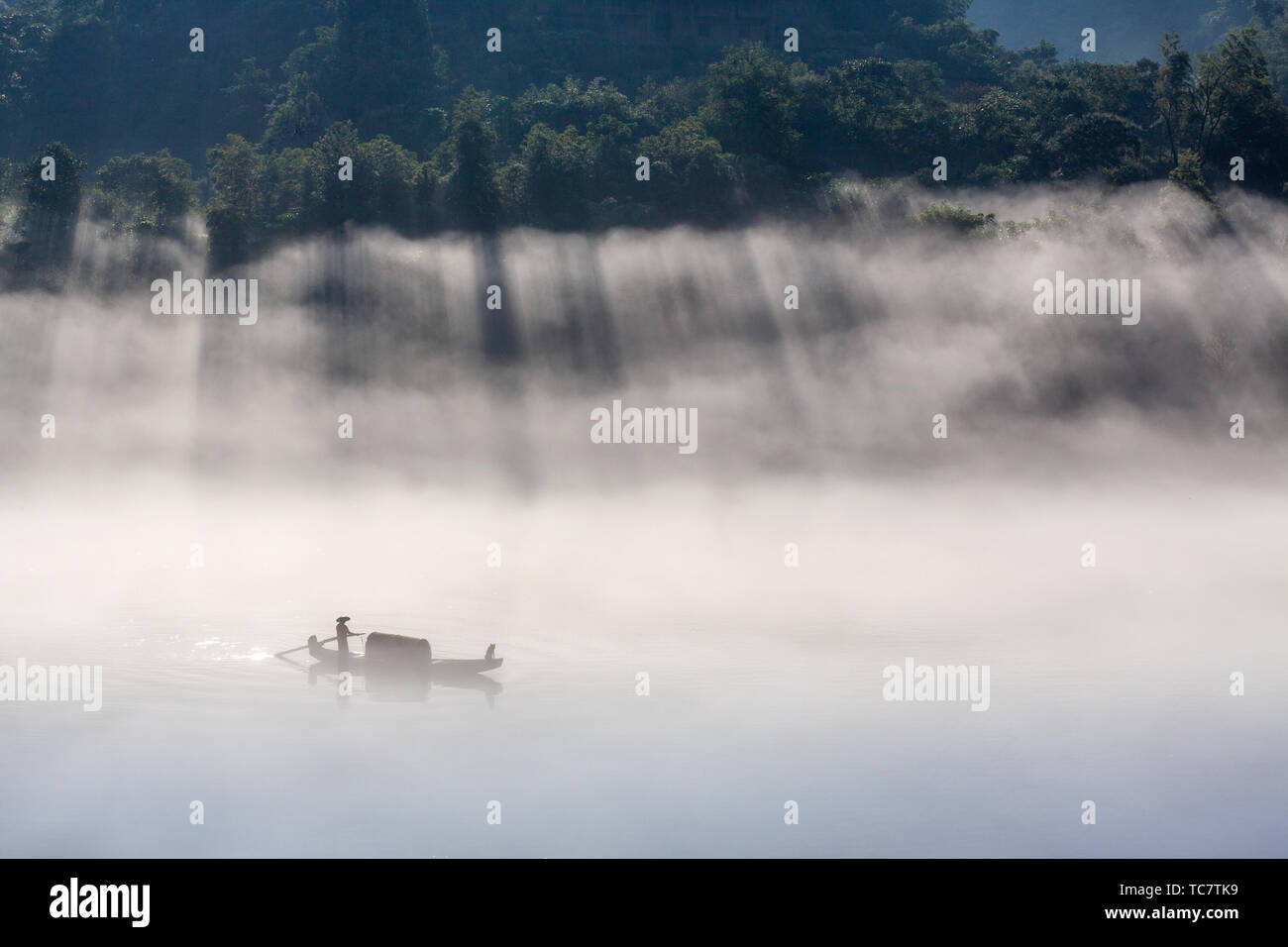 The fish beater in the morning fog lake Stock Photo - Alamy