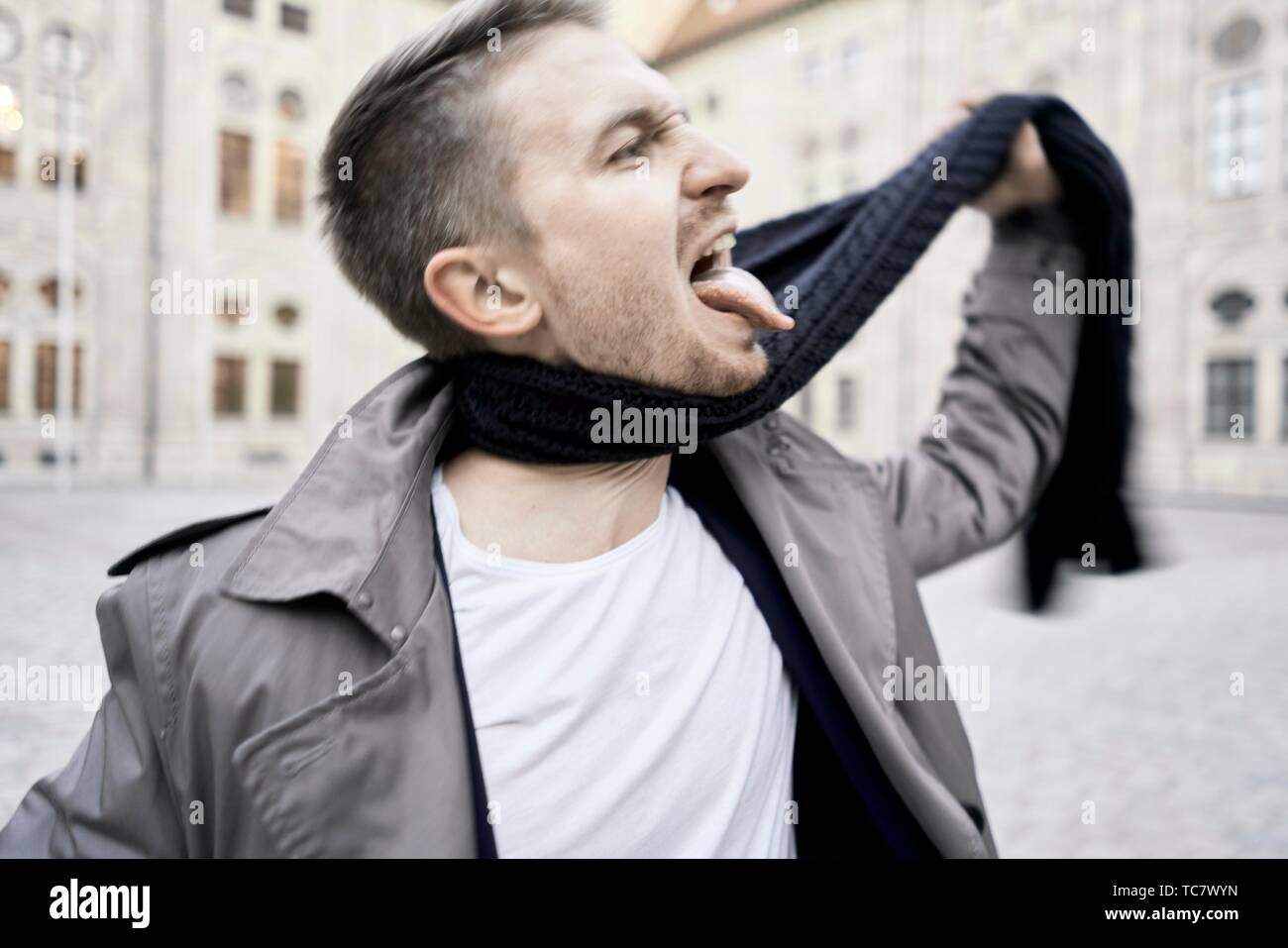 Young man strangling himself hi-res stock photography and images - Alamy