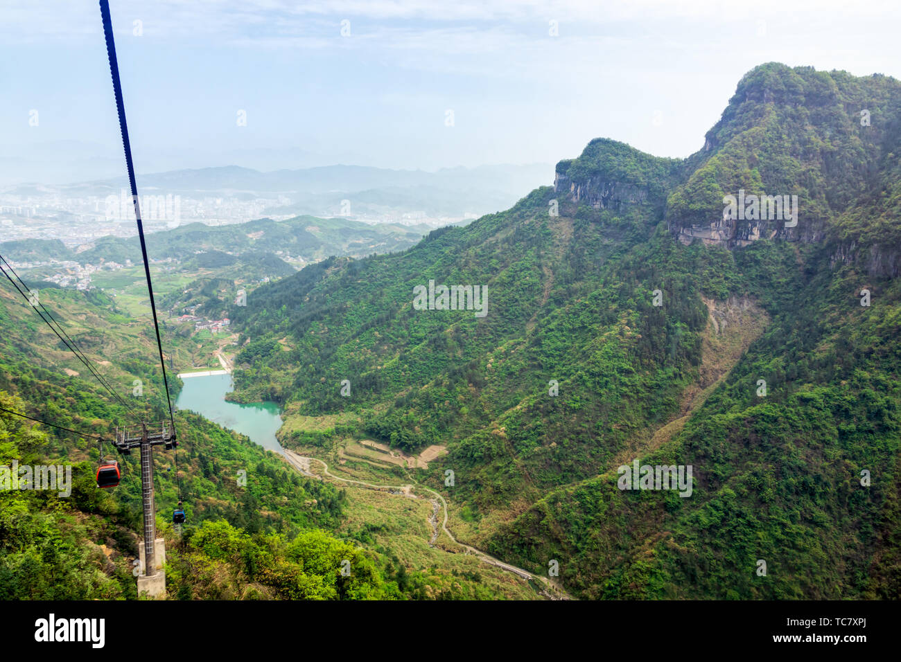 Cable carts on the way back to the far city in mist, high view point ...