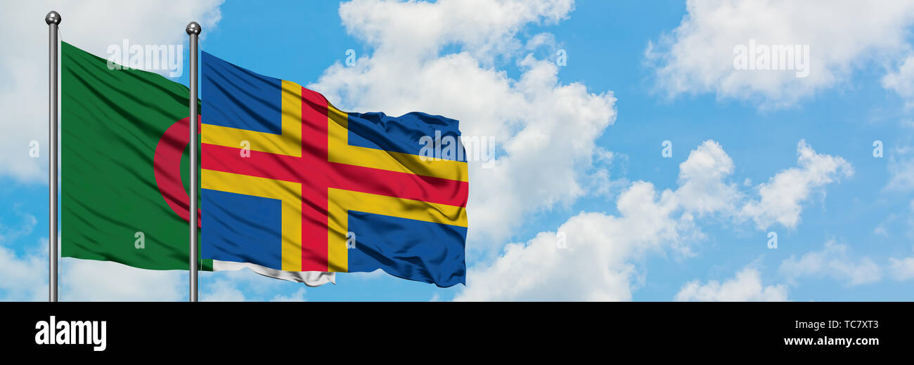 Algeria and Aland Islands flag waving in the wind against white cloudy ...