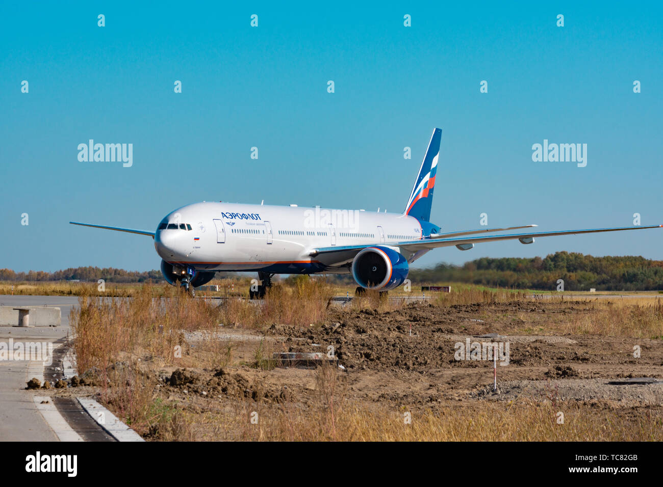 The plane lands on the runway at sunrise at high speed. Airport ...