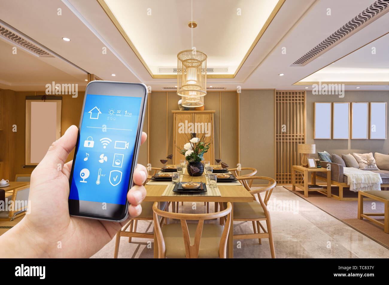 smart phone with smart home with modern dining room Stock Photo - Alamy