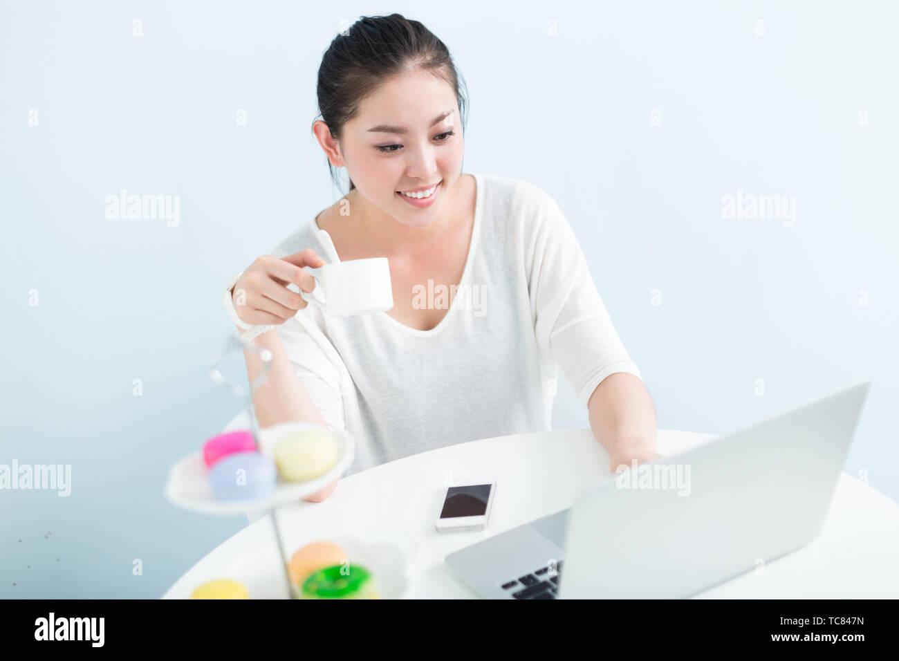 young pretty chinese woman working with laptop in office Stock Photo ...