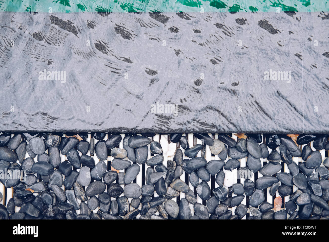 stone rock pebble on poolside of swimming pool Stock Photo - Alamy