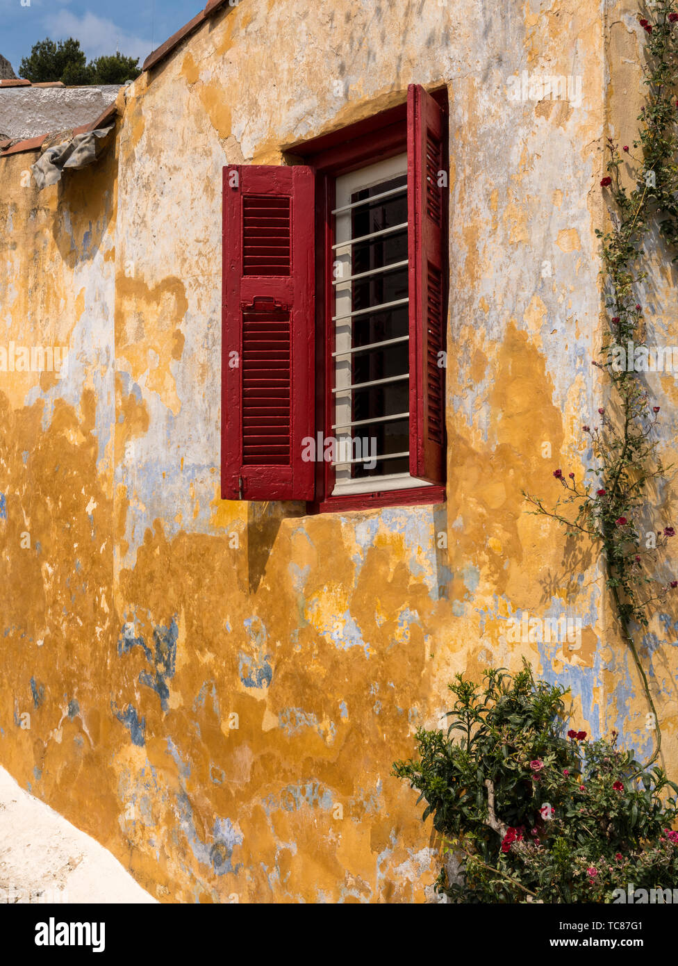 Red shutters on window in ancient district of Anafiotika in Athens ...