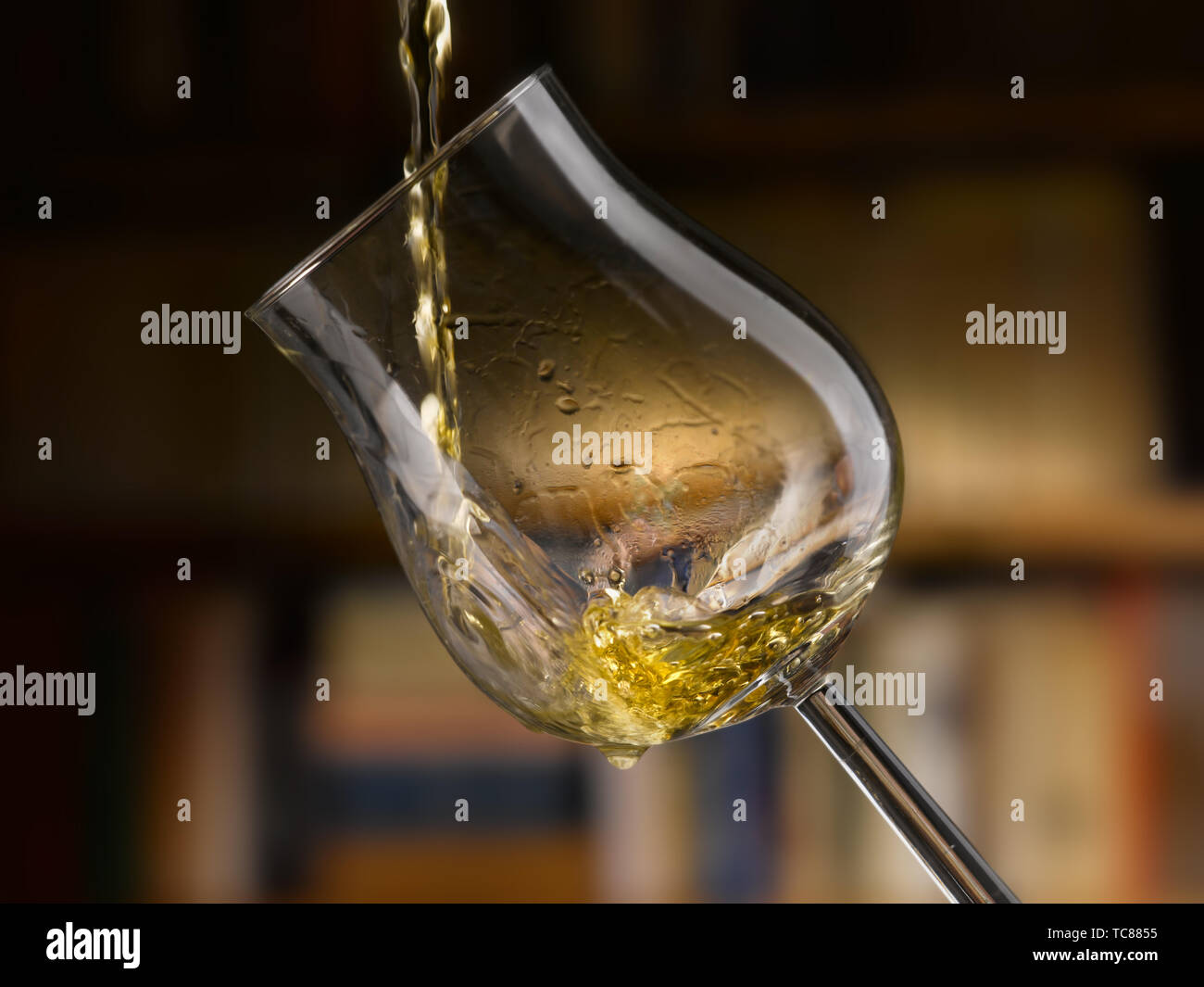 white wine poured in all its forms, library background Stock Photo - Alamy