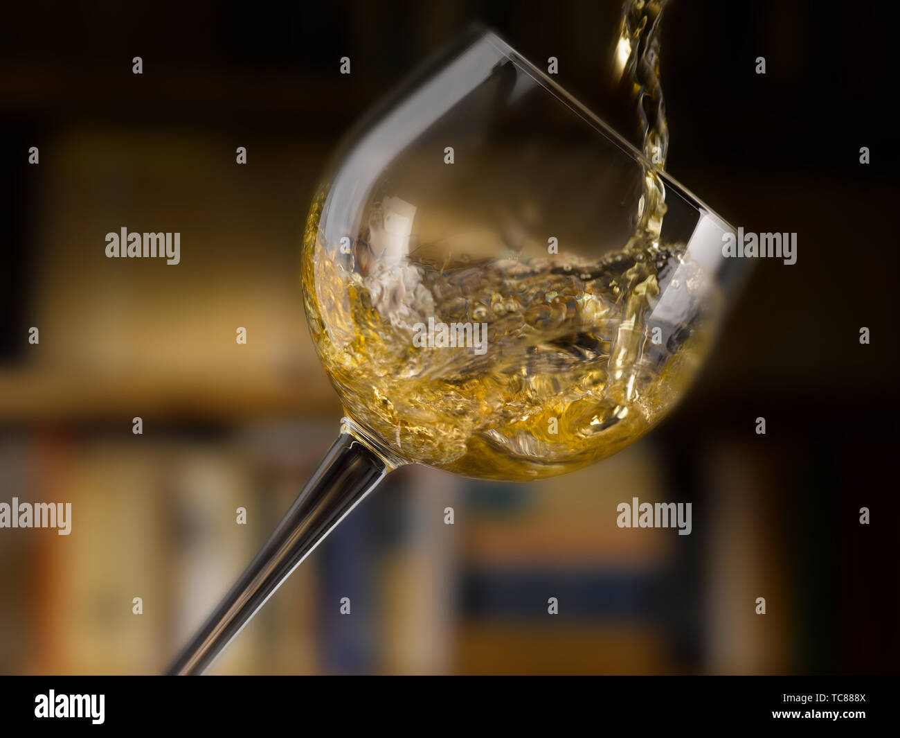 white wine poured in all its forms, library background Stock Photo - Alamy
