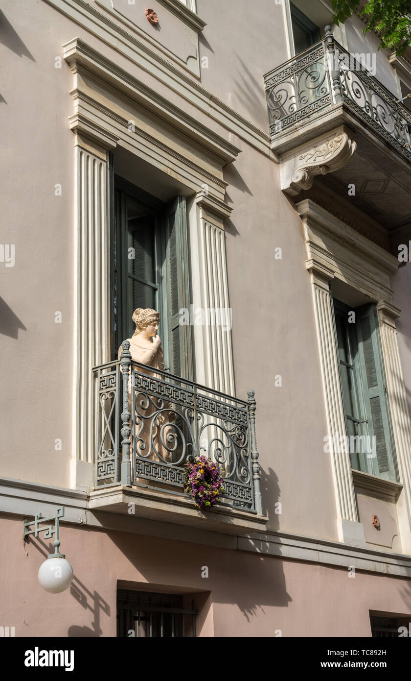 Statue on balcony of ancient residential district of Plaka in Athens ...