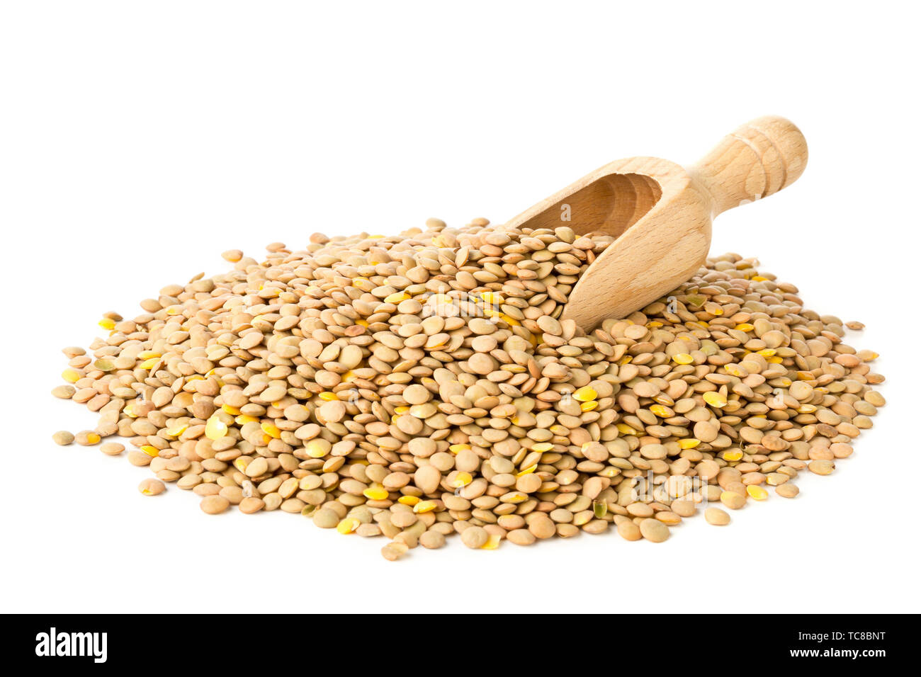 Heap of raw, dry, uncooked brown lentil legumes with wooden scoop over ...
