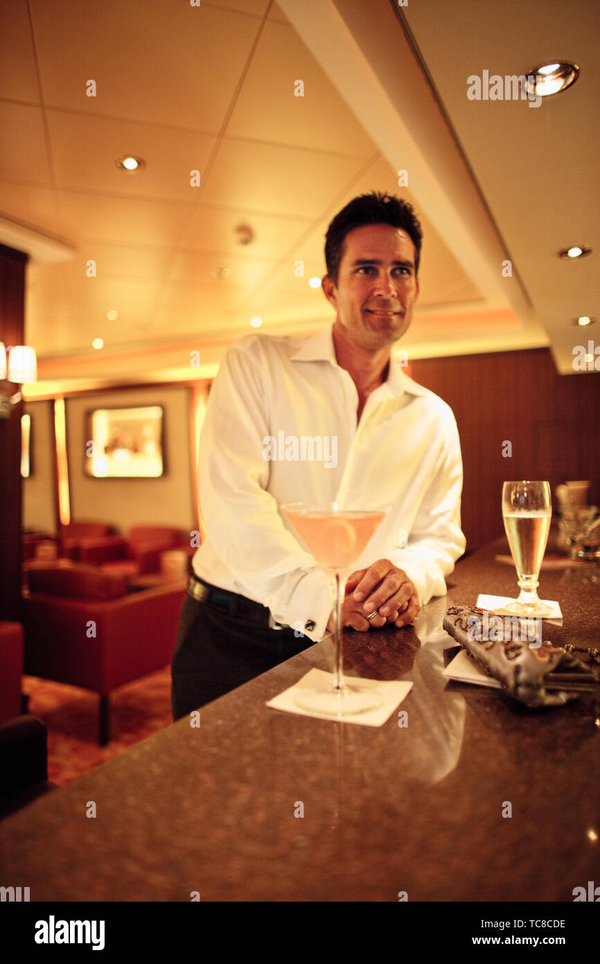 Man waiting at bar with cocktail Stock Photo - Alamy