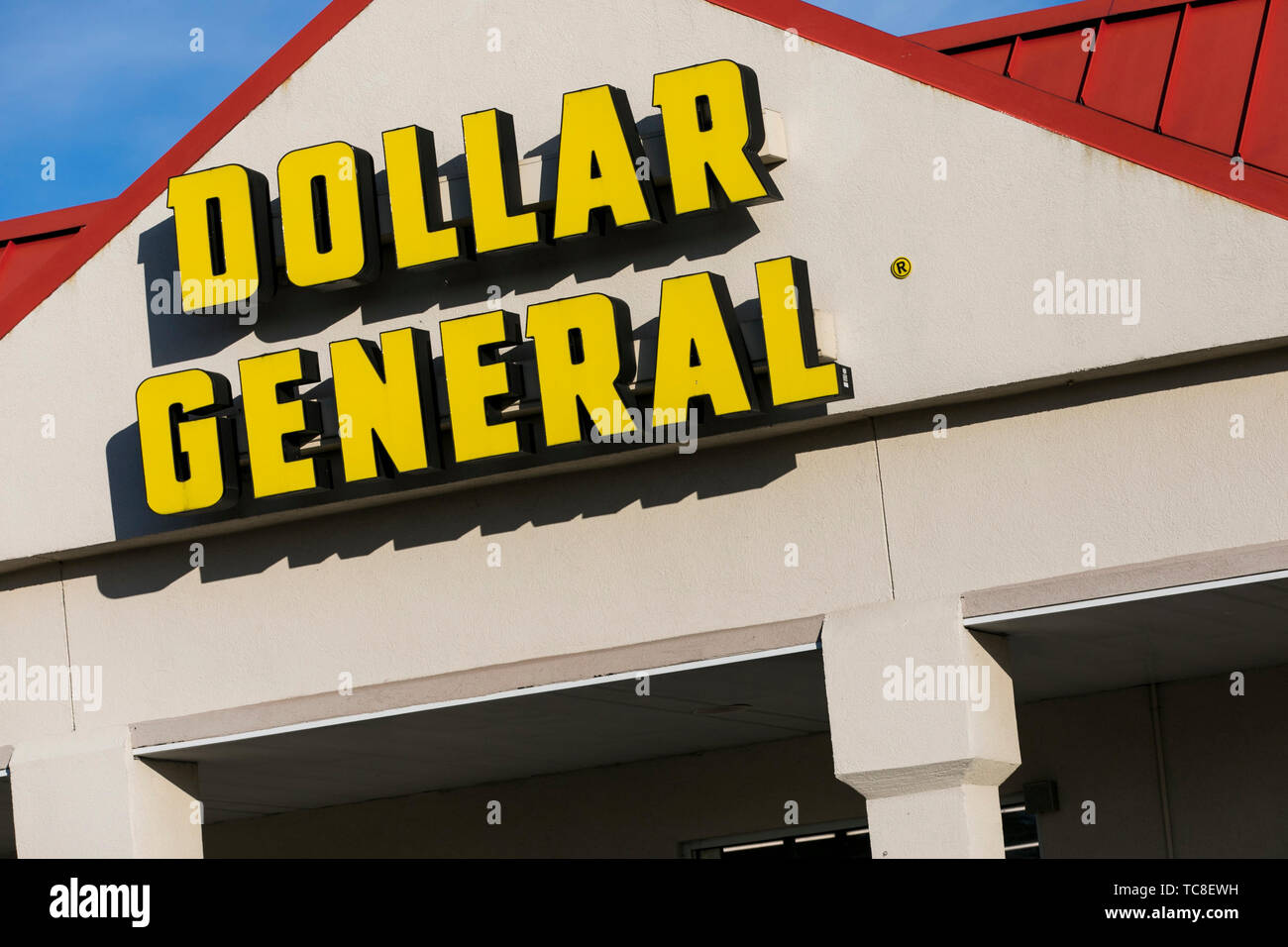A logo sign outside of a Dollar General retail store location in ...