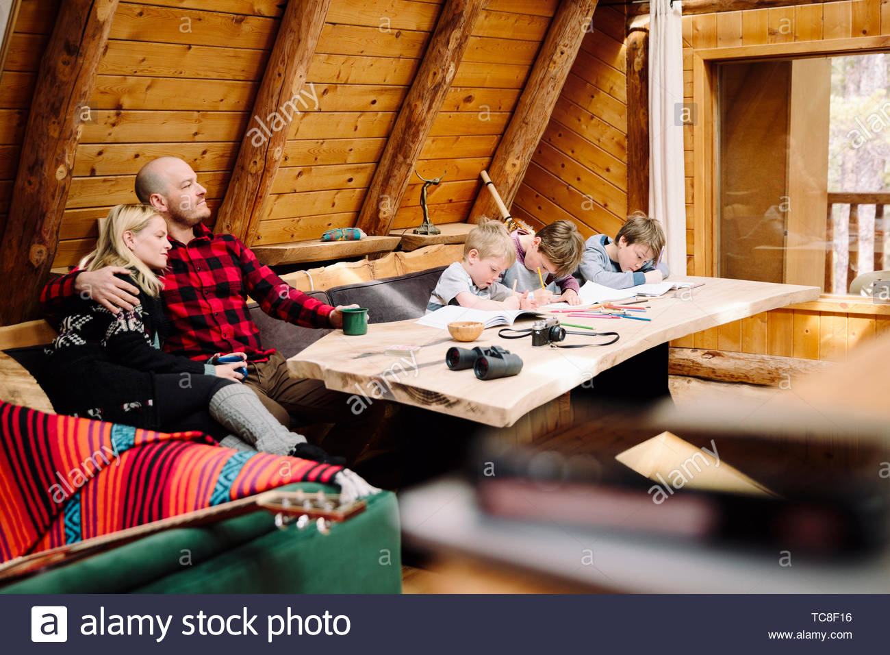 Family sitting around in cabin hi-res stock photography and images - Alamy