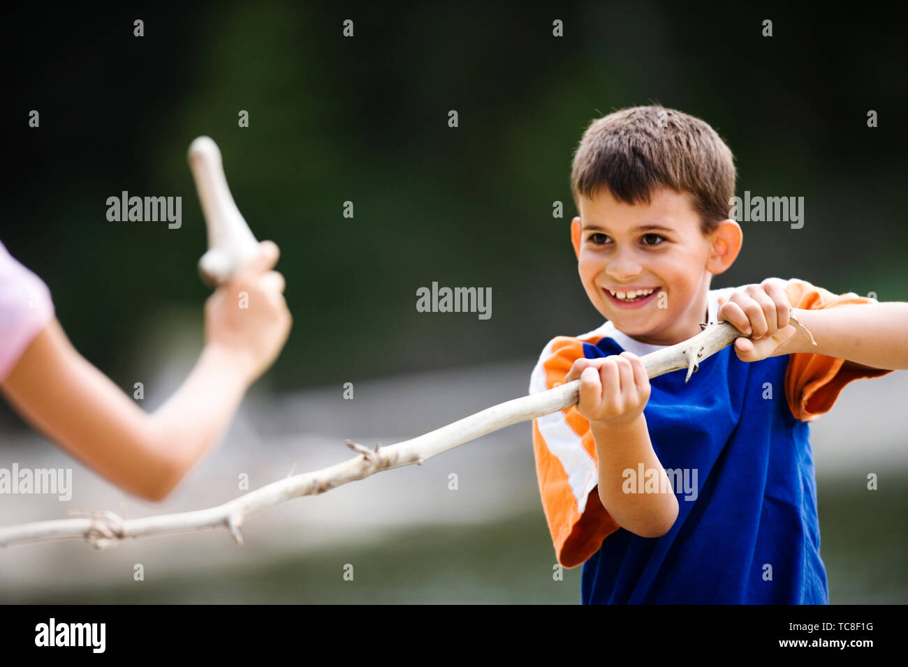 Boys holding sticks hi-res stock photography and images - Alamy