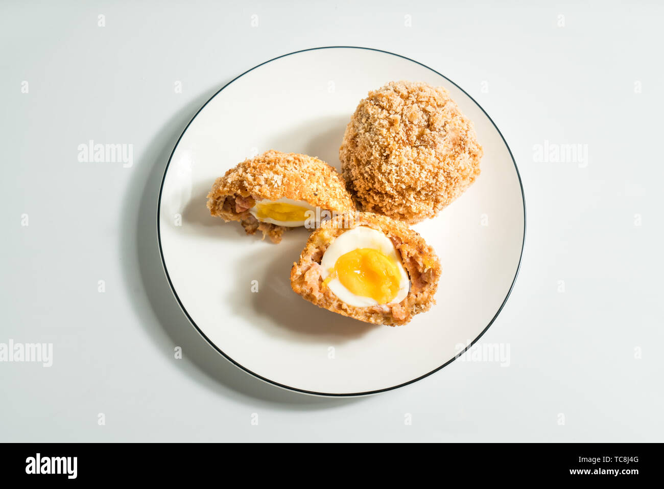 Scottish egg pendulum plate with white background Stock Photo - Alamy