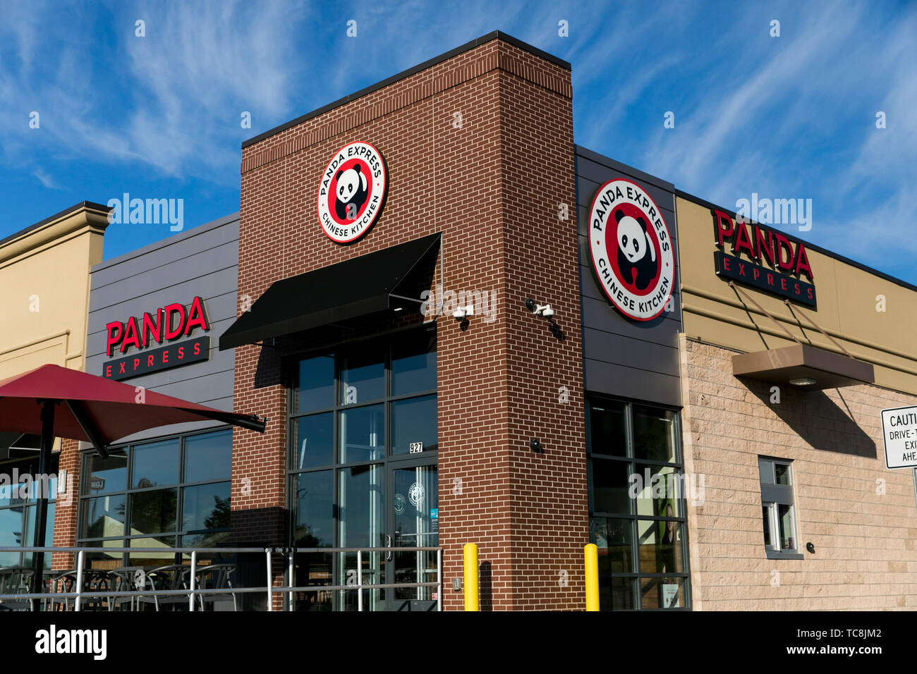 A logo sign outside of a Panda Express fast food restaurant location in ...