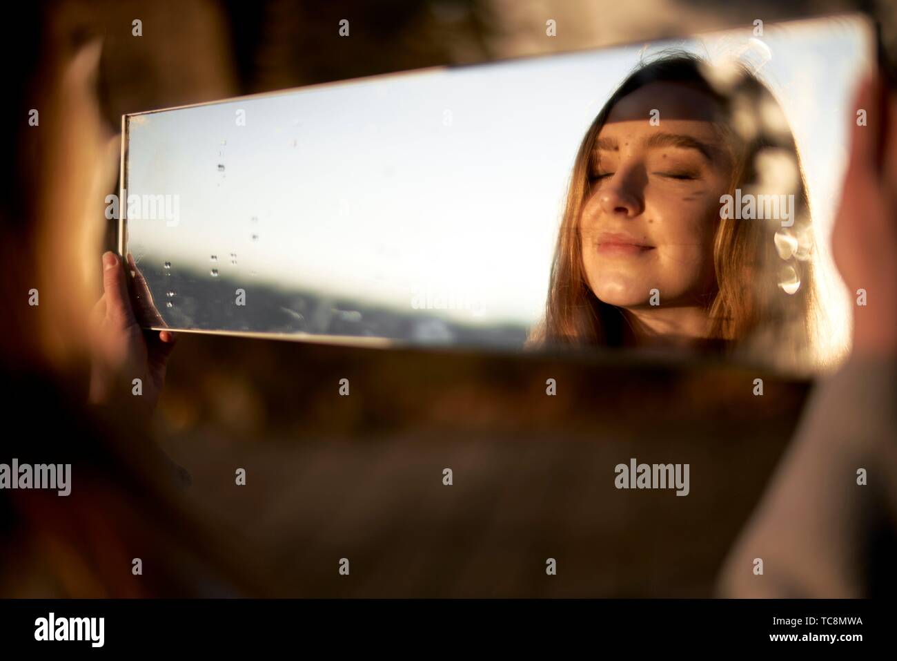 Woman face reflected in mirror hi-res stock photography and images - Alamy