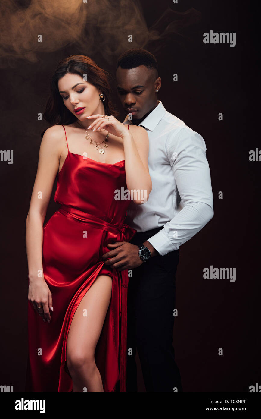 Beautiful Sensual Interracial Couple In Formal Wear Posing On Black