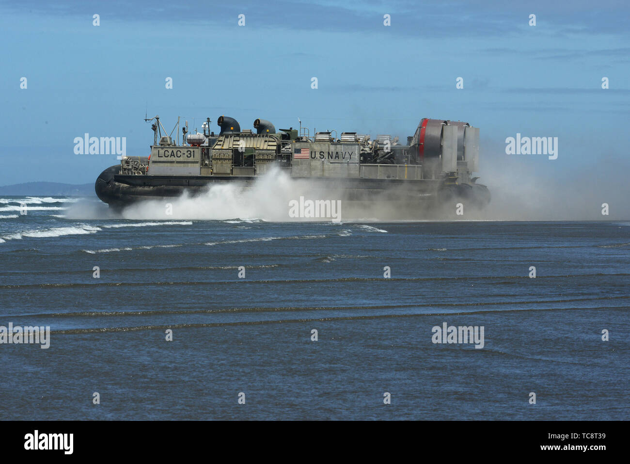 A U.S. Navy (Landing Craft Air Cushion) LCAC-31 leaves the shore at the ...