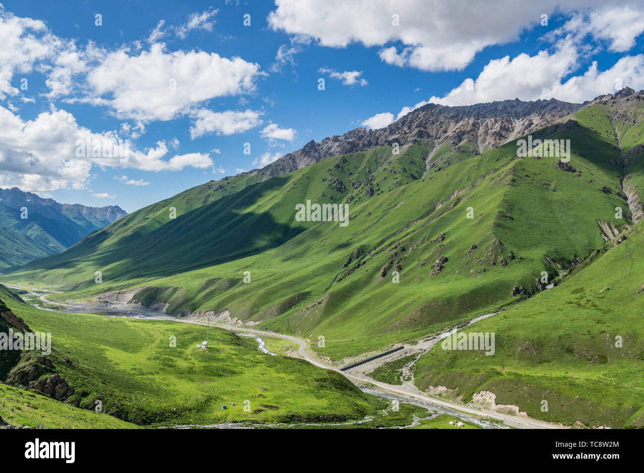 Alpine grasslands along the G217 Duku Highway under the summer blue sky ...