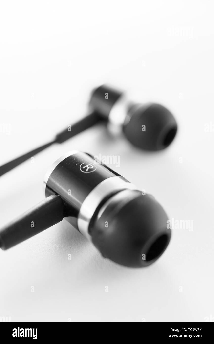 Classic black earbuds Stock Photo - Alamy