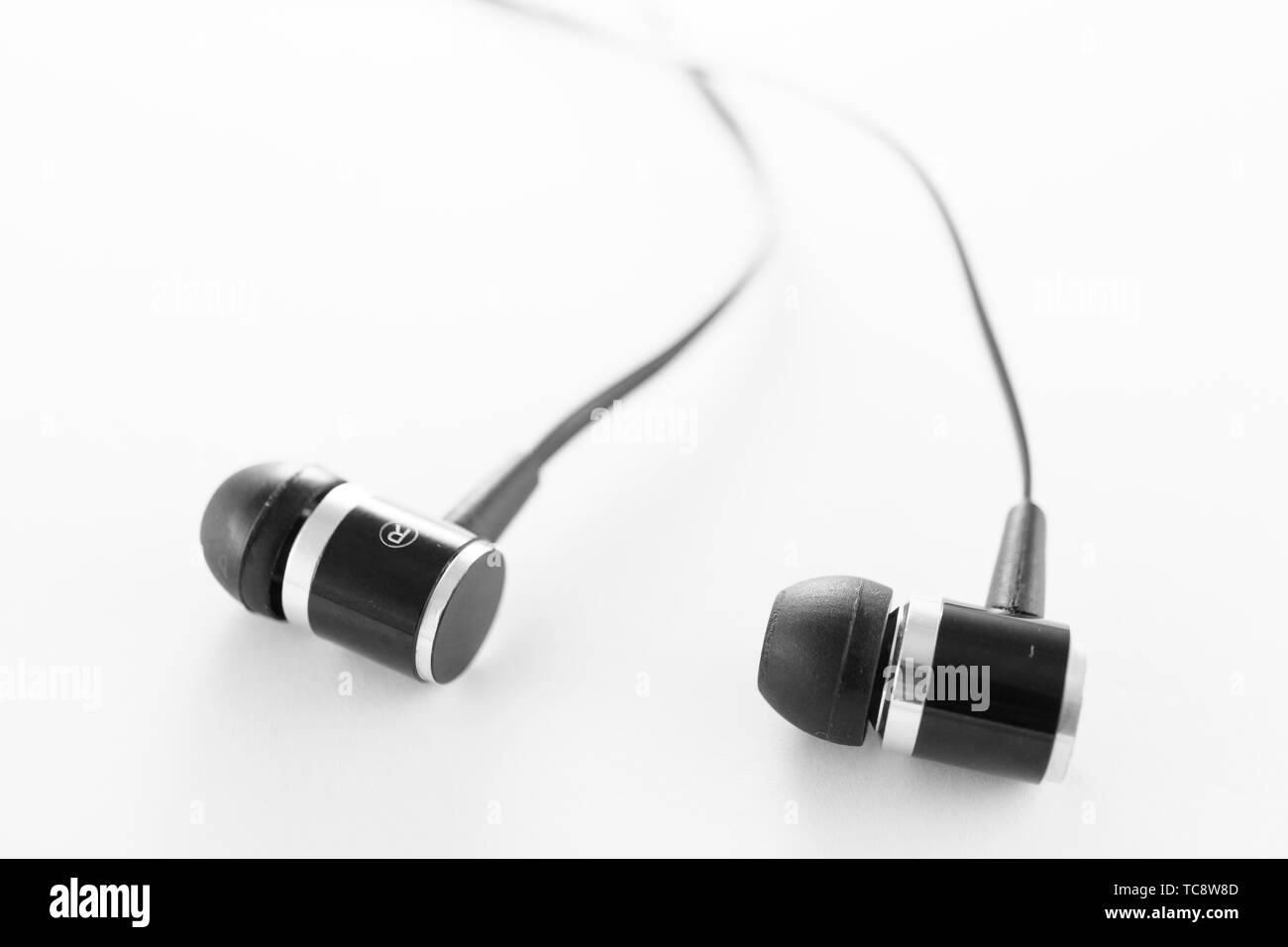 Black wired earbuds Stock Photo - Alamy