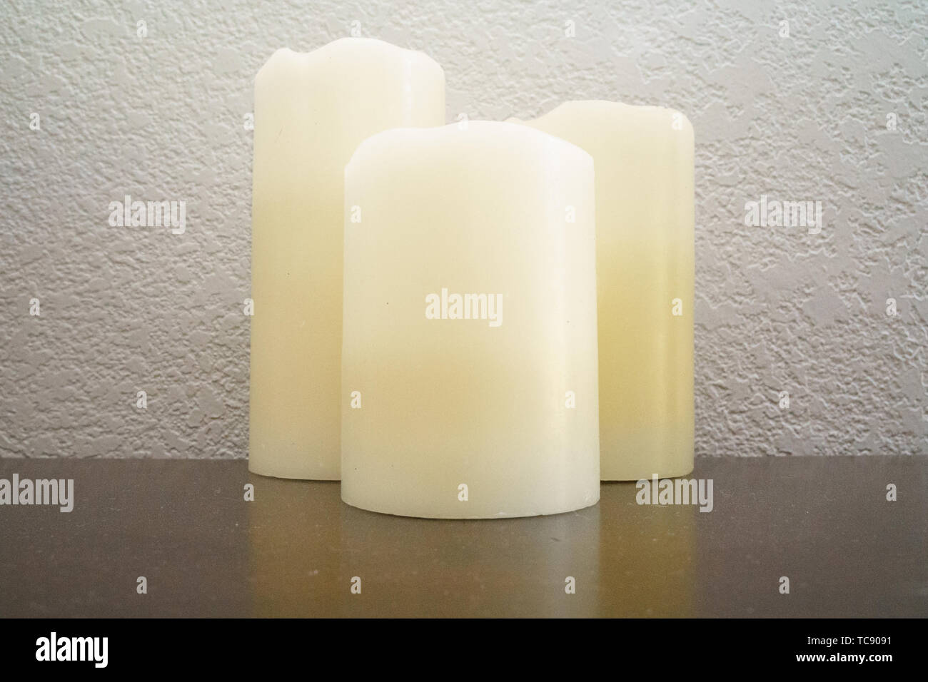 Three tall candles hi-res stock photography and images - Alamy
