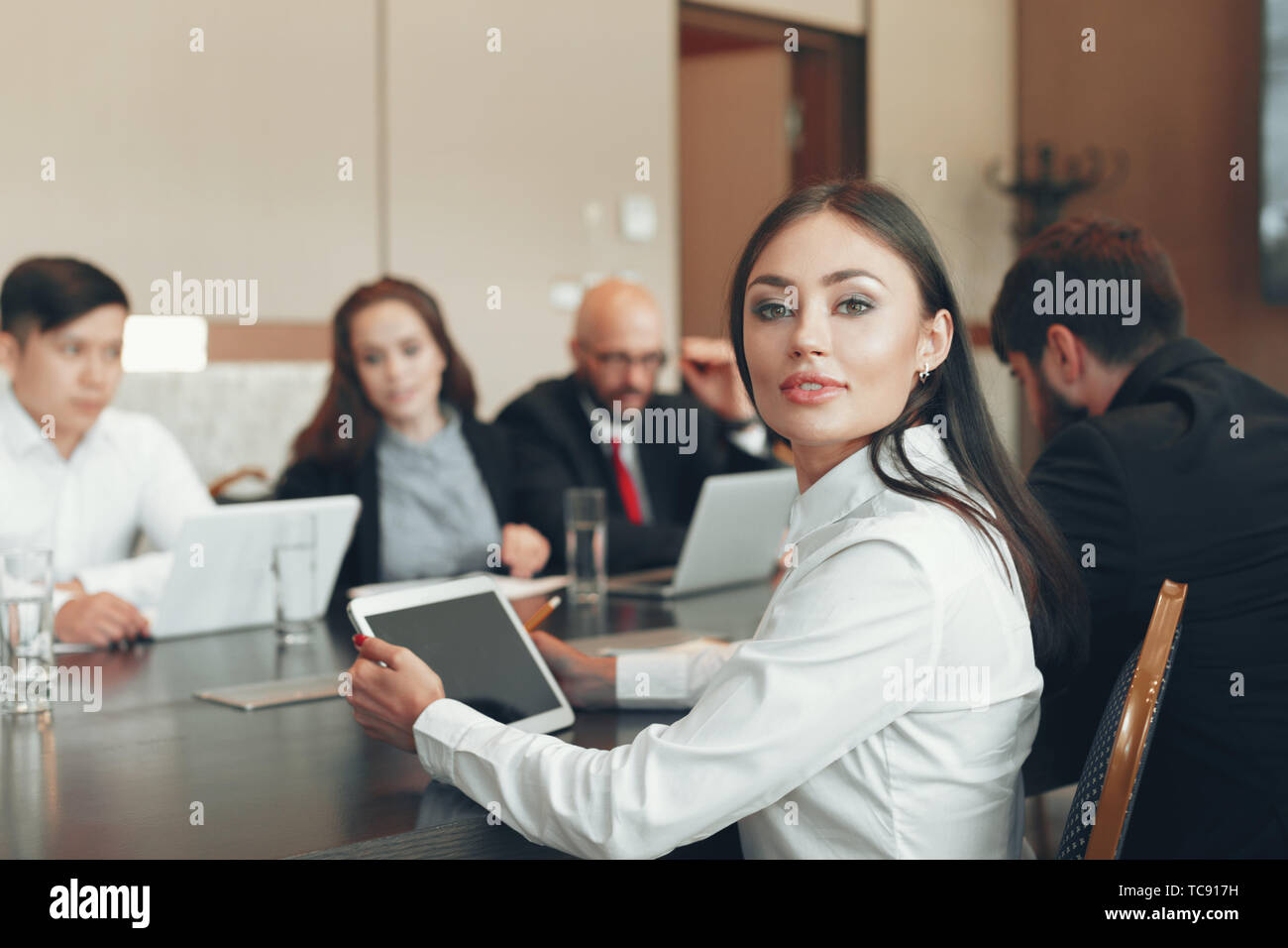 Business people working together at conference table Stock Photo - Alamy