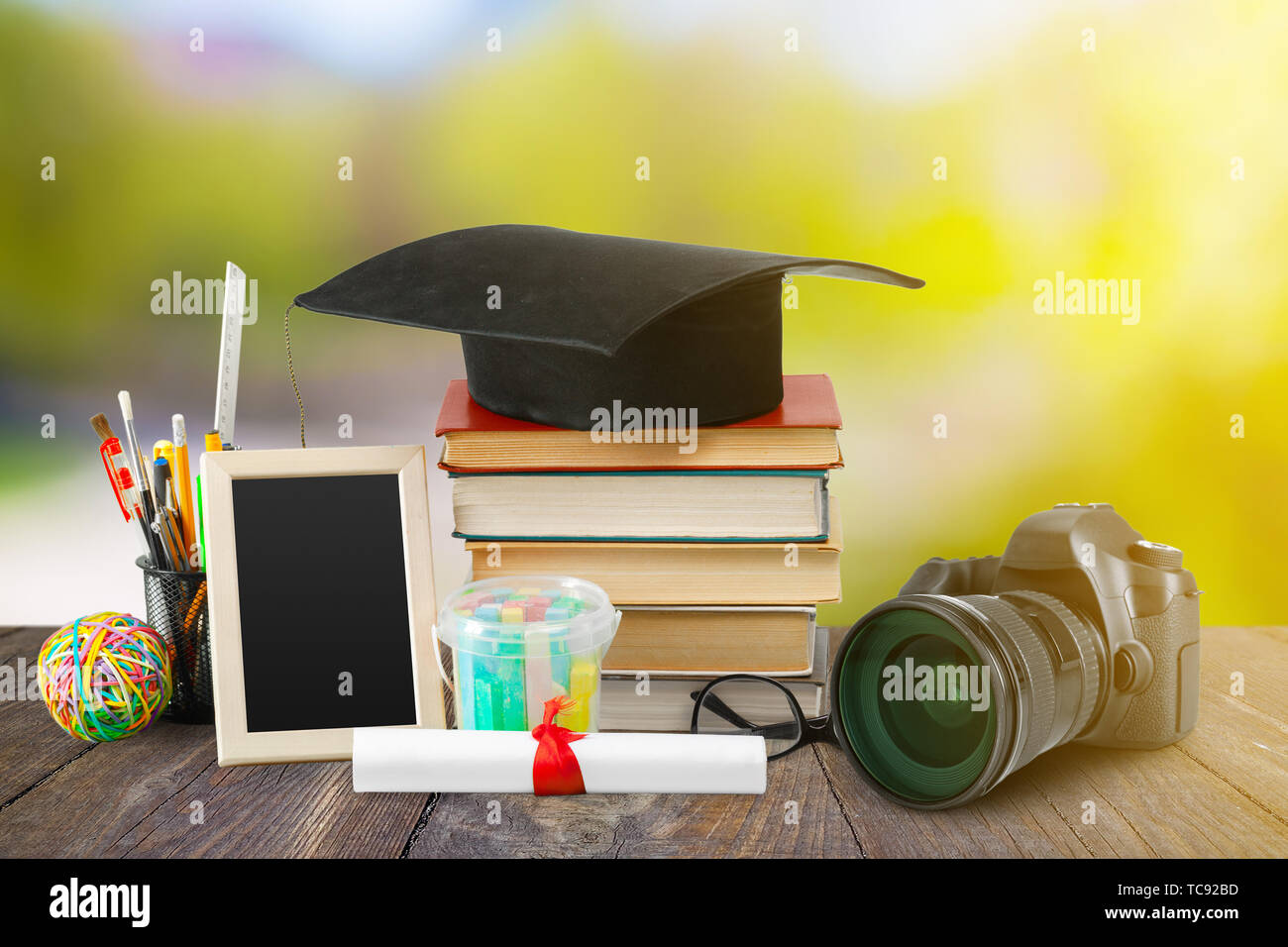 Graduation from school/university composition. Pile of books, diploma ...