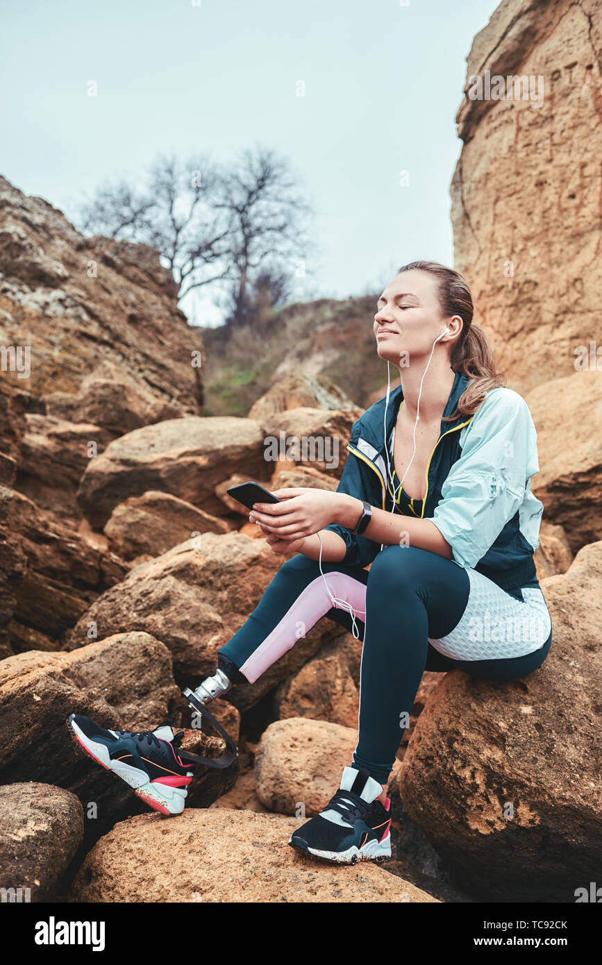 Dreaming. Happy disabled women in sport wear with leg prosthesis ...